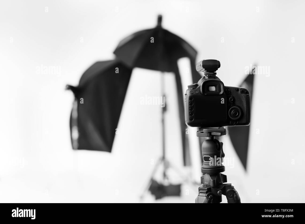 Professional camera on tripod in photo studio Stock Photo - Alamy