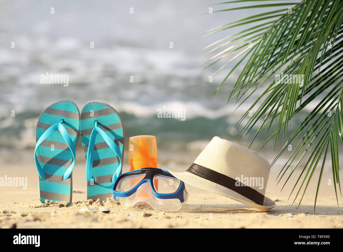 Set of beach items on sand near sea Stock Photo - Alamy
