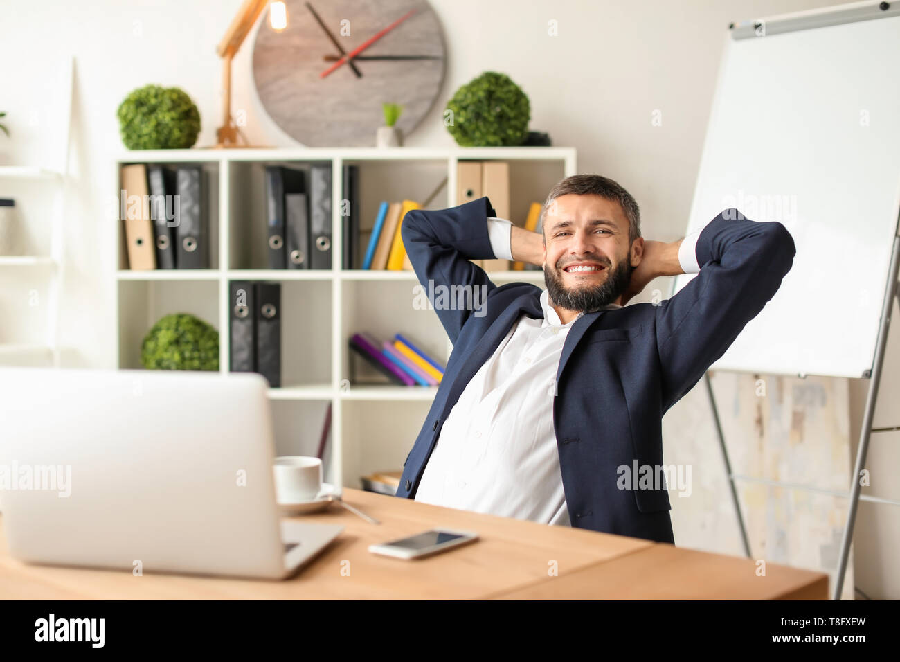 Businessman resting at workplace Stock Photo - Alamy