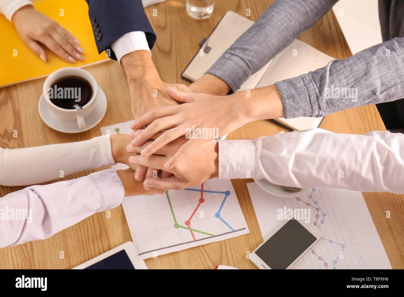 Business team putting hands together as symbol of unity Stock Photo - Alamy