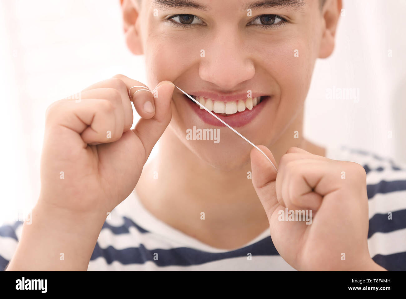 Man flossing teeth hi-res stock photography and images - Alamy