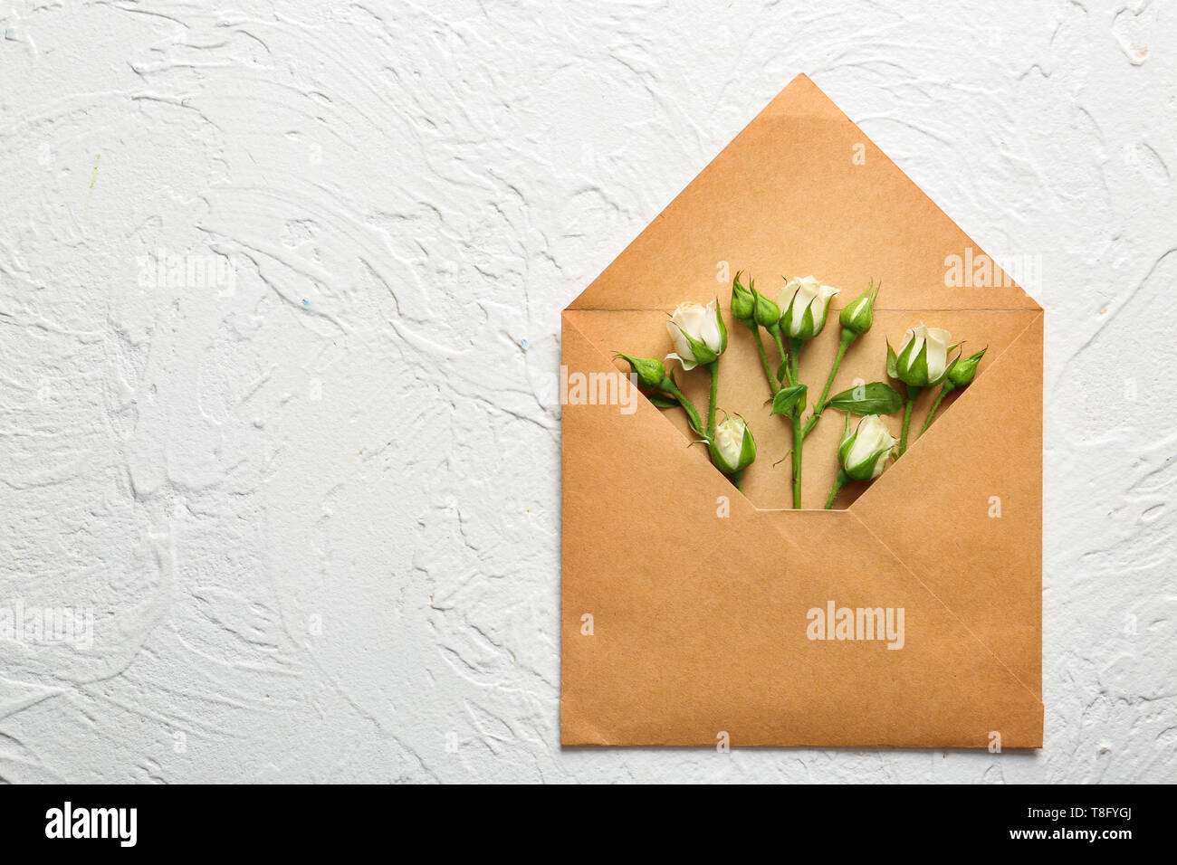 Open mail envelope with rose flowers on light background Stock Photo ...