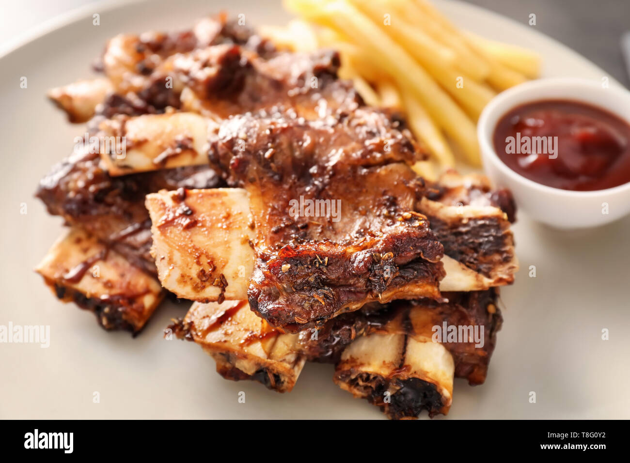 Delicious grilled ribs on plate, closeup Stock Photo - Alamy