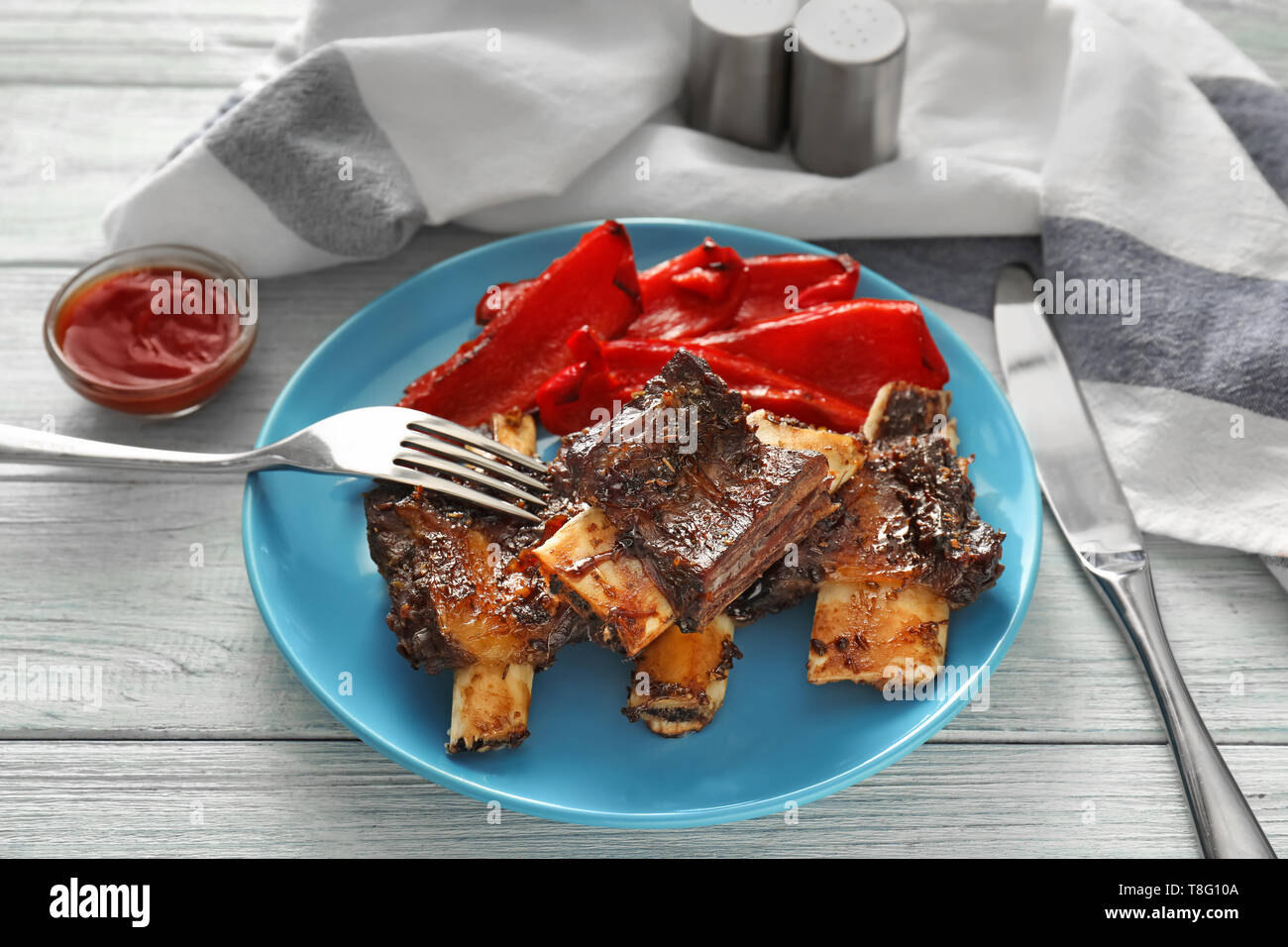 Delicious grilled ribs with pepper on plate Stock Photo - Alamy