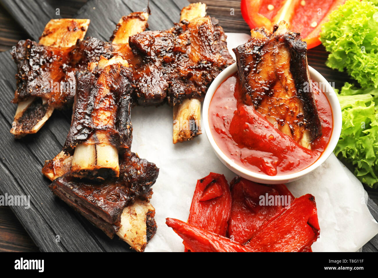 Delicious grilled ribs with sauce on wooden board, closeup Stock Photo ...