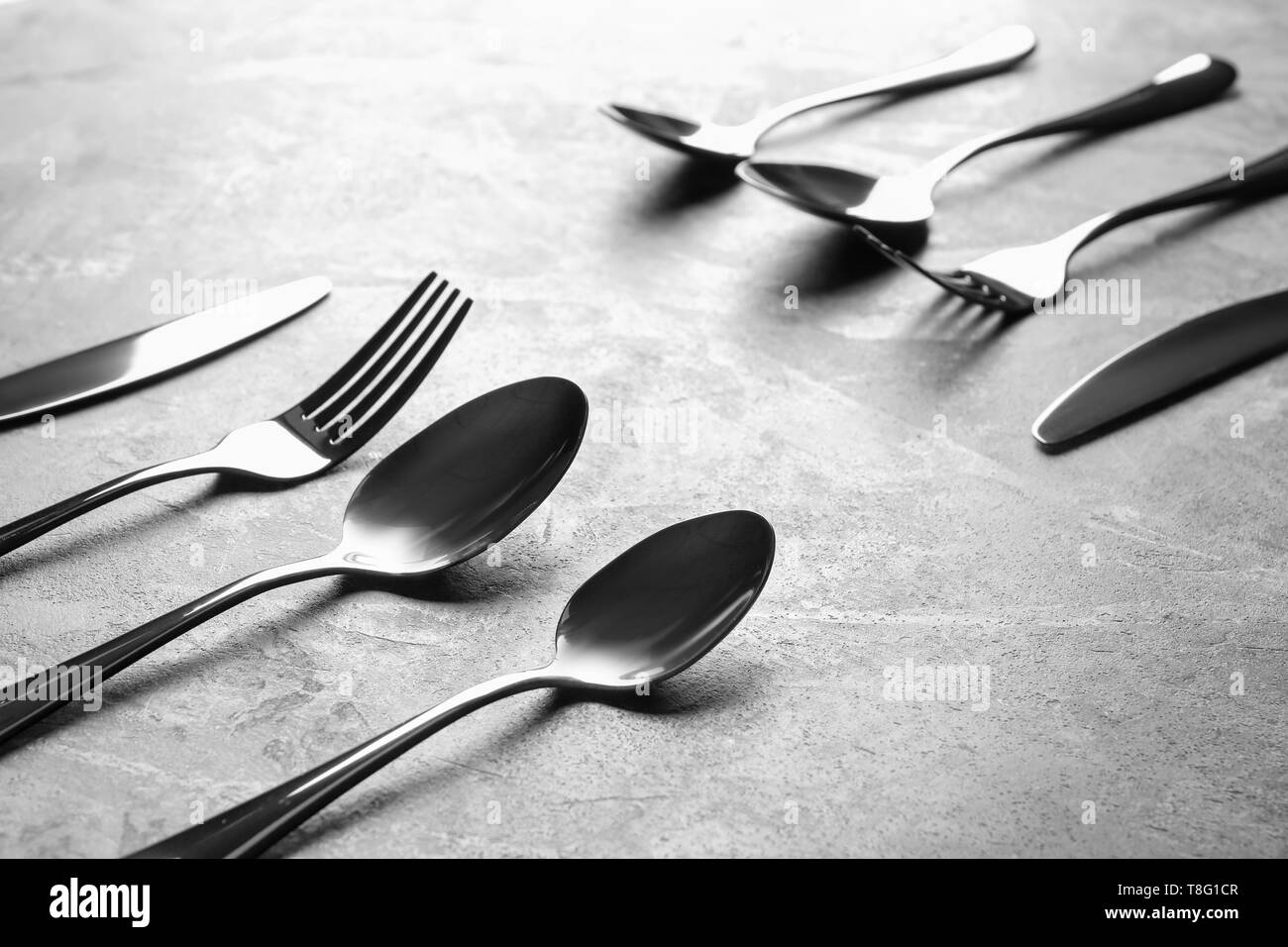 Set of cutlery on grey background Stock Photo - Alamy