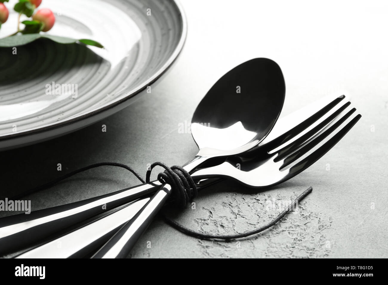 Cutlery with plate on light table Stock Photo - Alamy