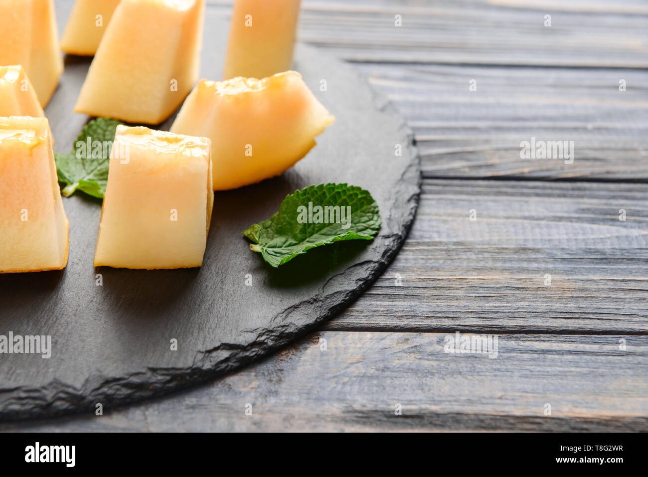 Sliced ripe melon on slate plate Stock Photo - Alamy