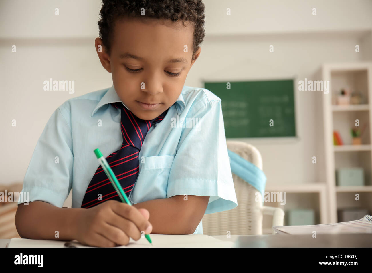 African-American boy doing exercise in classroom Stock Photo - Alamy