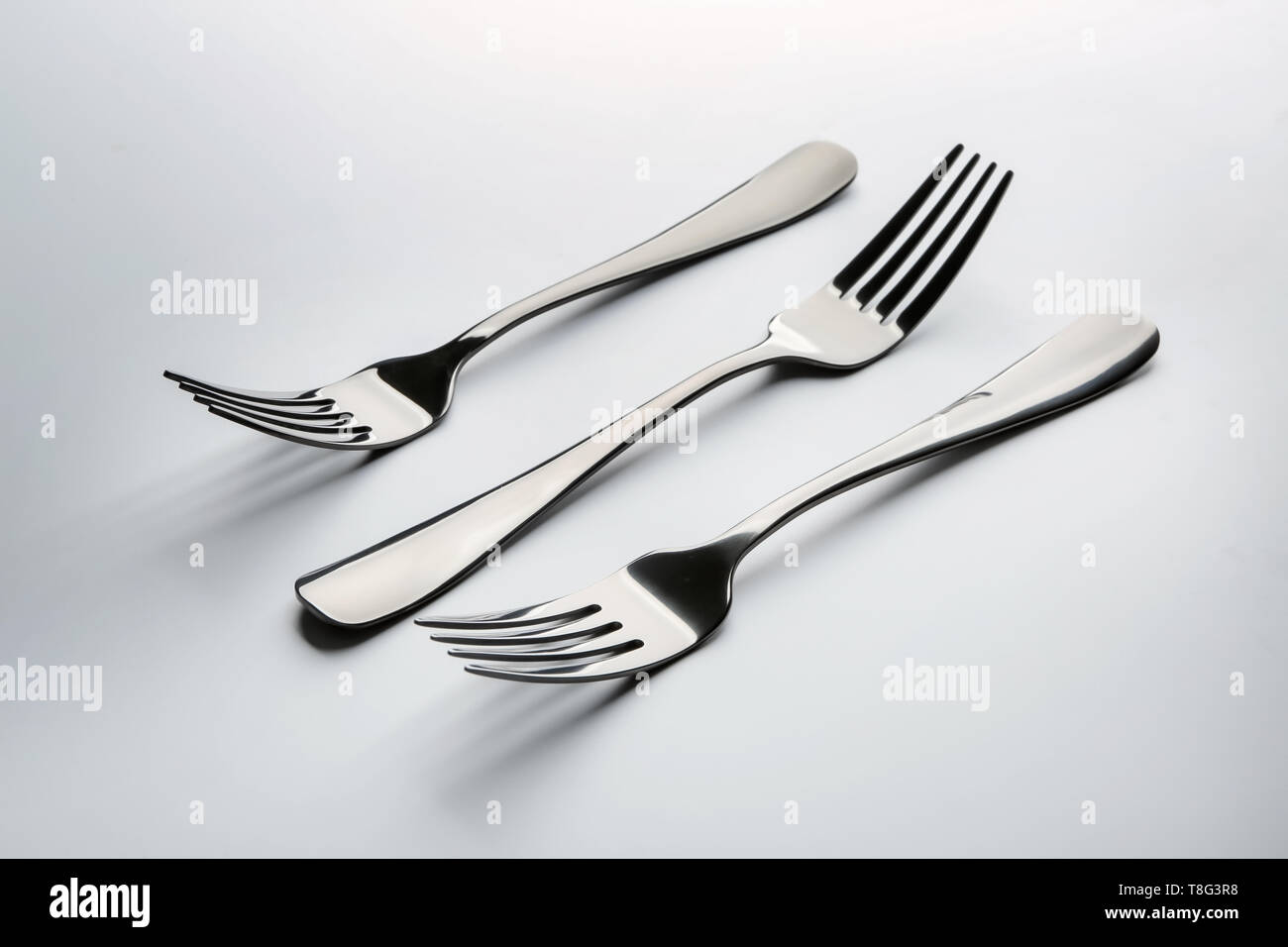 Forks on white background Stock Photo - Alamy