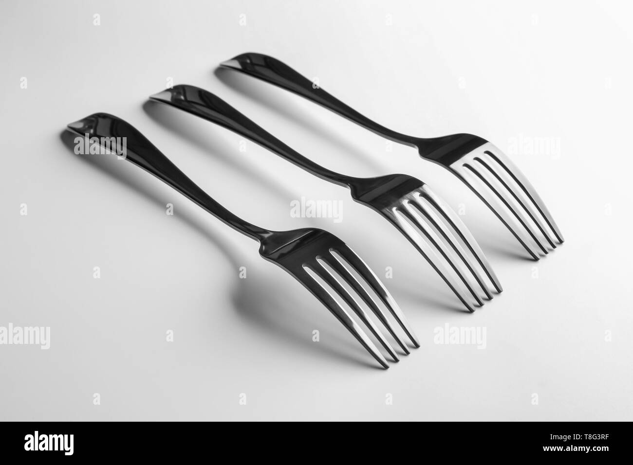 Forks on white background Stock Photo - Alamy