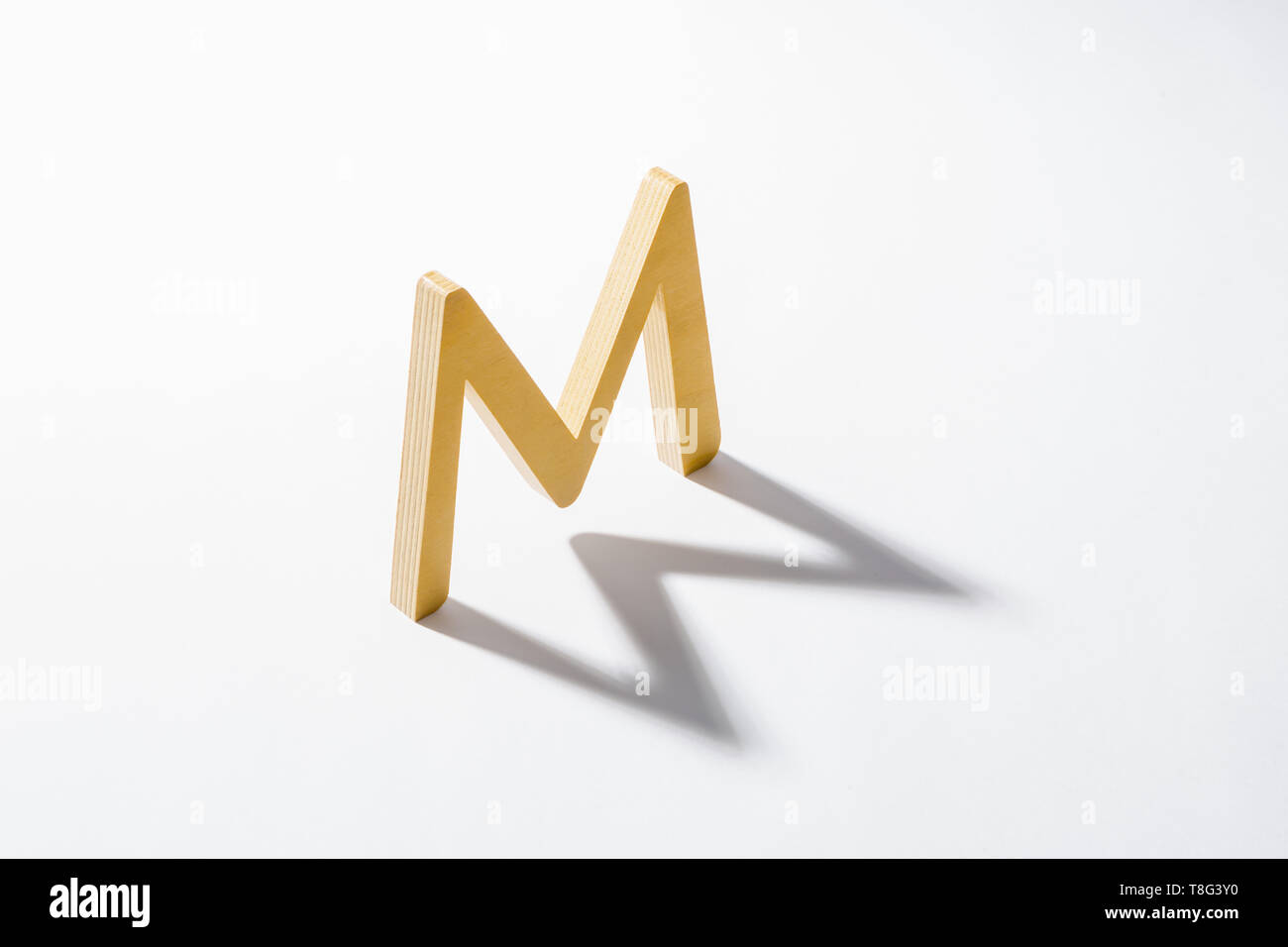 Wooden Alphabet M and Shadow Reflection Stock Photo - Alamy