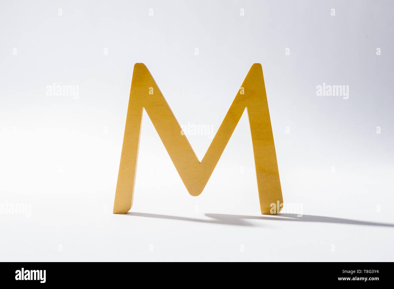 Wooden Alphabet M and Shadow Reflection Stock Photo - Alamy