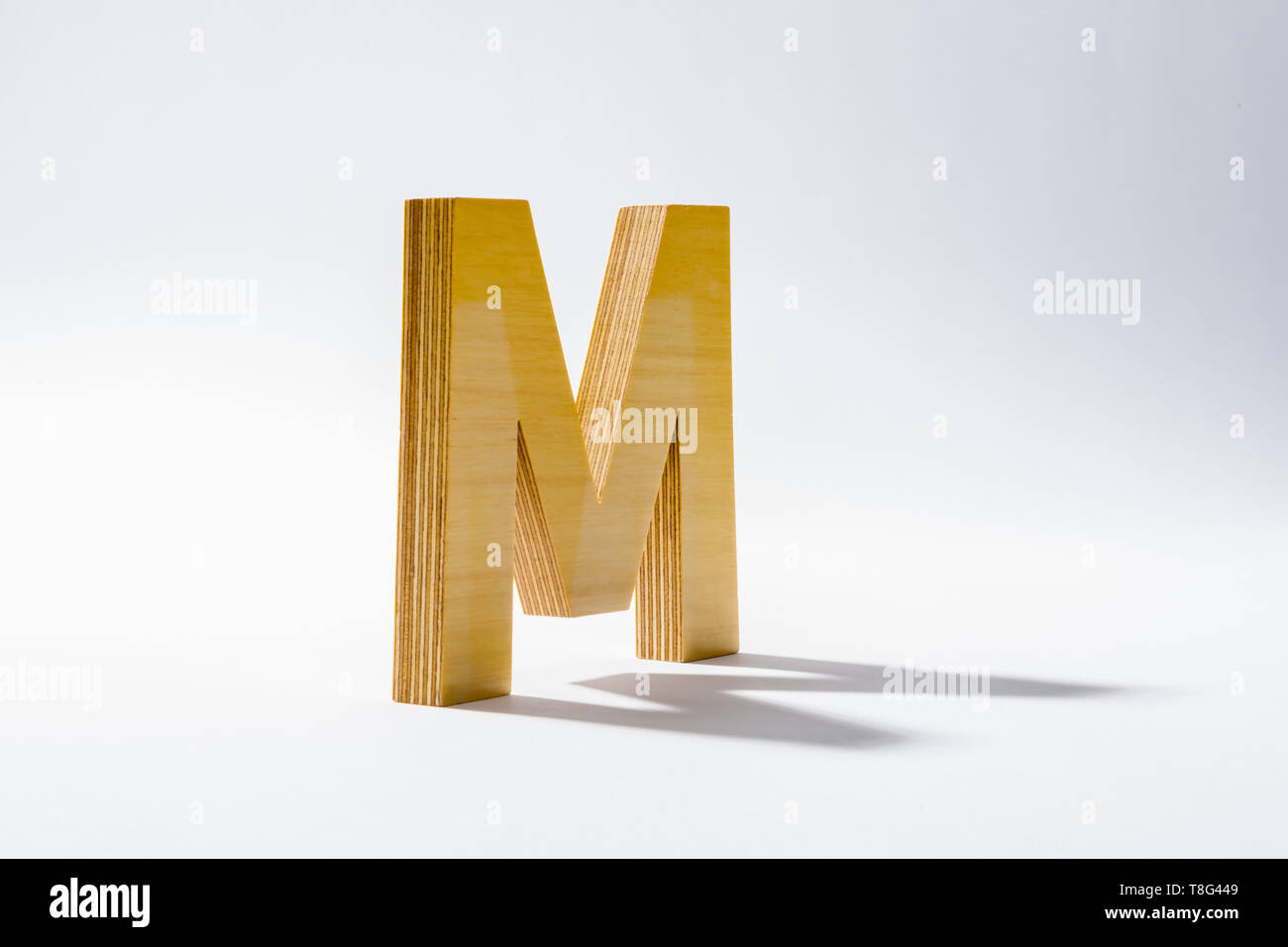Wooden Alphabet M and Shadow Reflection Stock Photo - Alamy