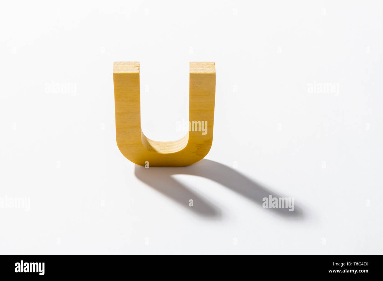 Wooden Alphabet U and Shadow Reflection Stock Photo - Alamy