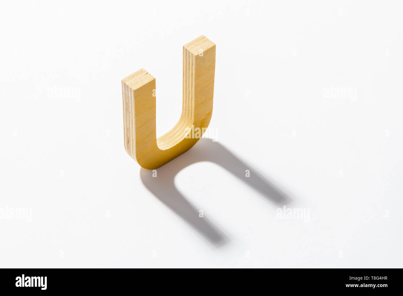 Wooden Alphabet U and Shadow Reflection Stock Photo - Alamy