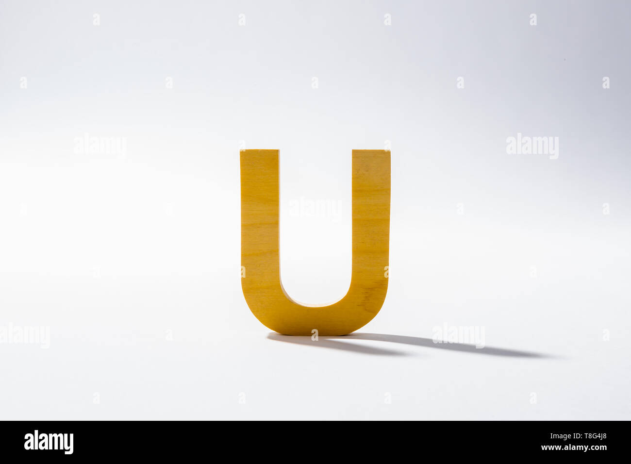 Wooden Alphabet U and Shadow Reflection Stock Photo - Alamy