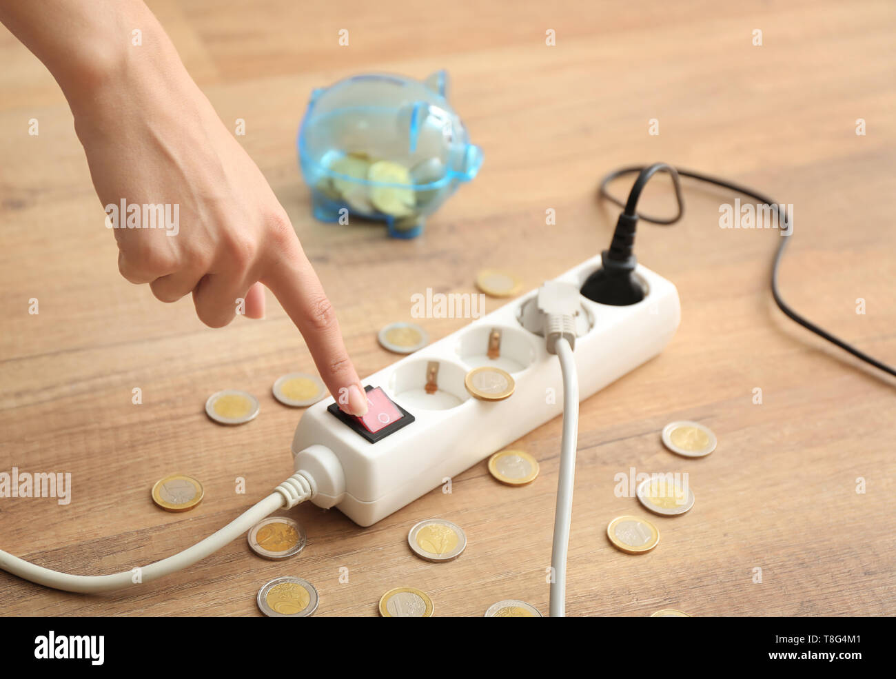 Woman pressing a power button of extension cord indoors. Electricity ...