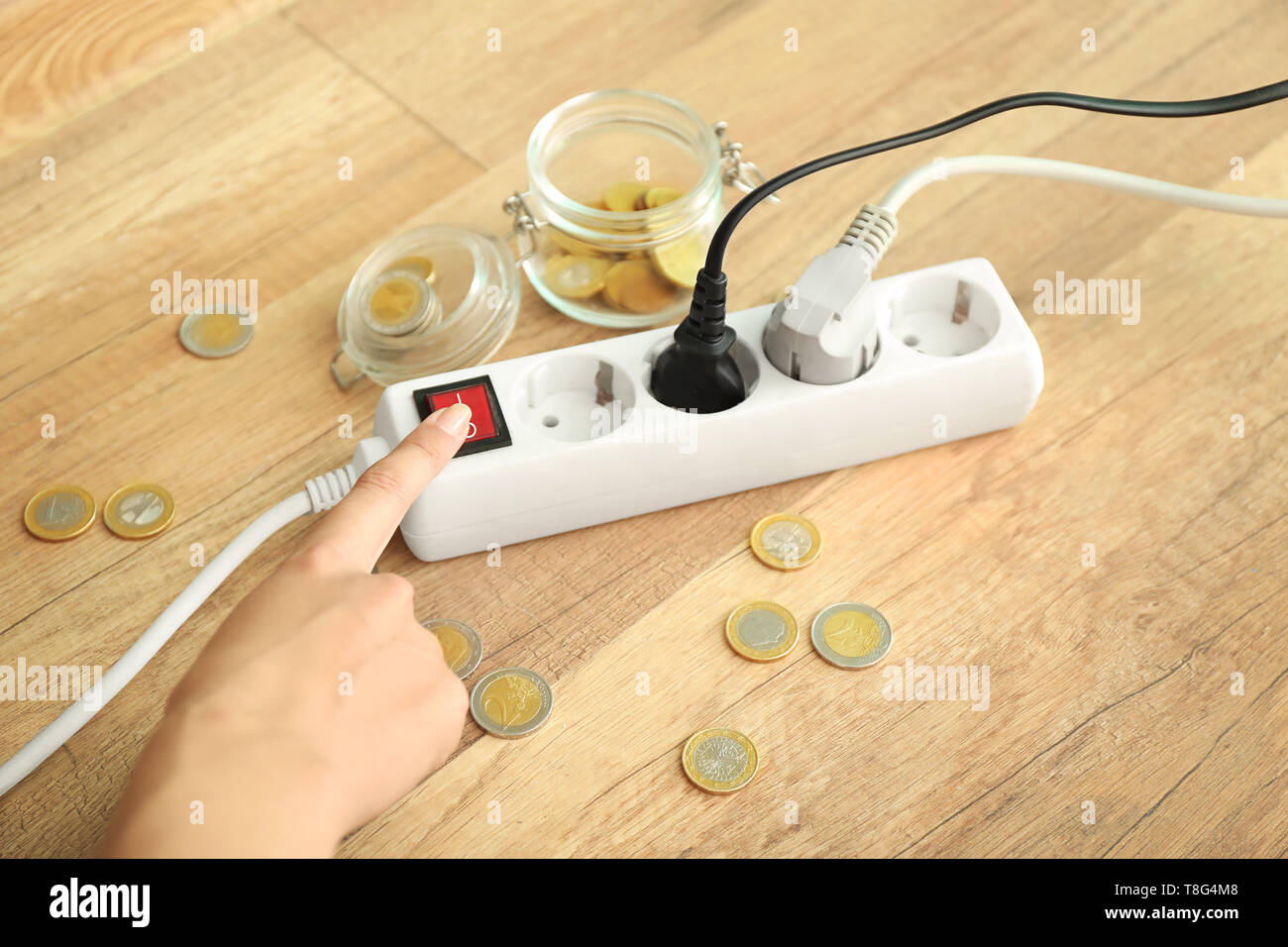 Woman pressing a power button of extension cord indoors. Electricity ...