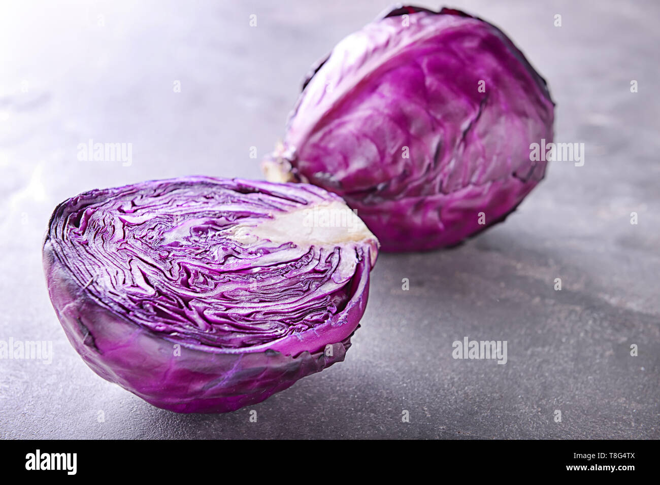 Whole and cut red cabbage on grey table Stock Photo - Alamy