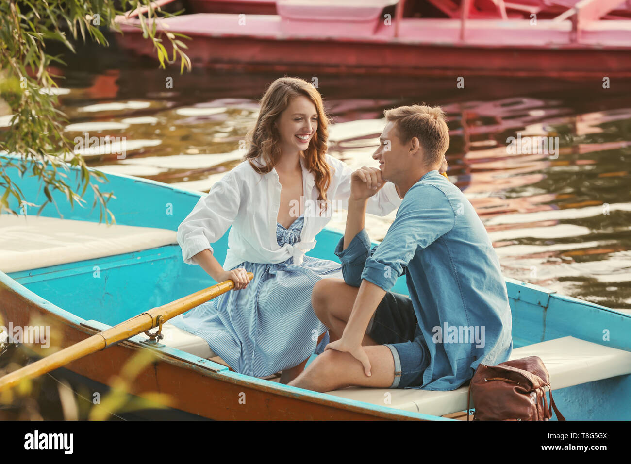 Cute young couple having romantic date in boat Stock Photo - Alamy