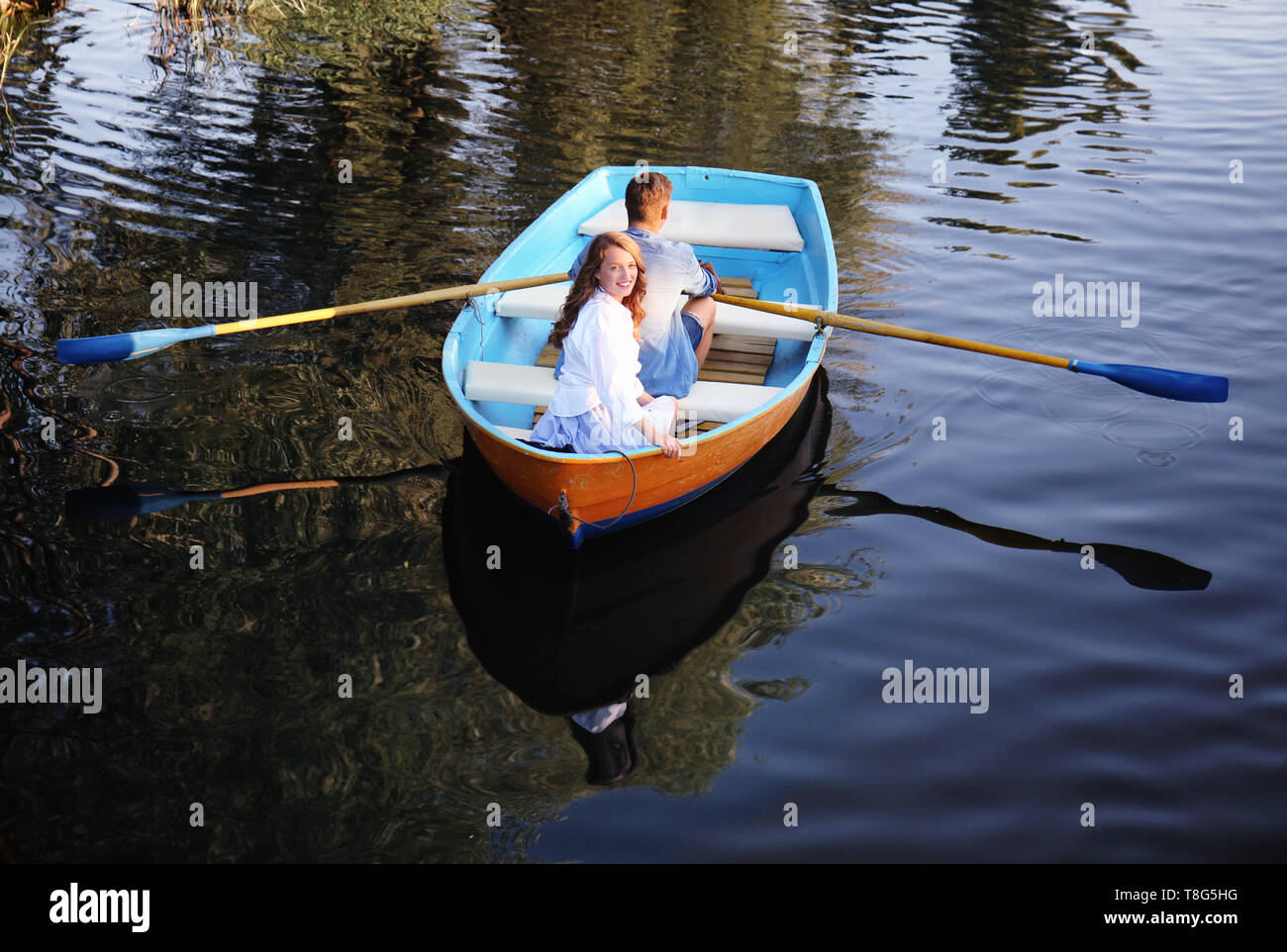 Cute young couple having romantic date in boat Stock Photo - Alamy