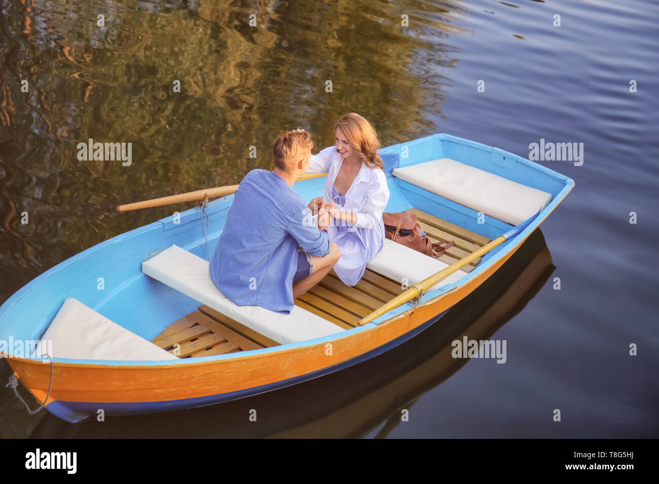 Cute young couple having romantic date in boat Stock Photo - Alamy