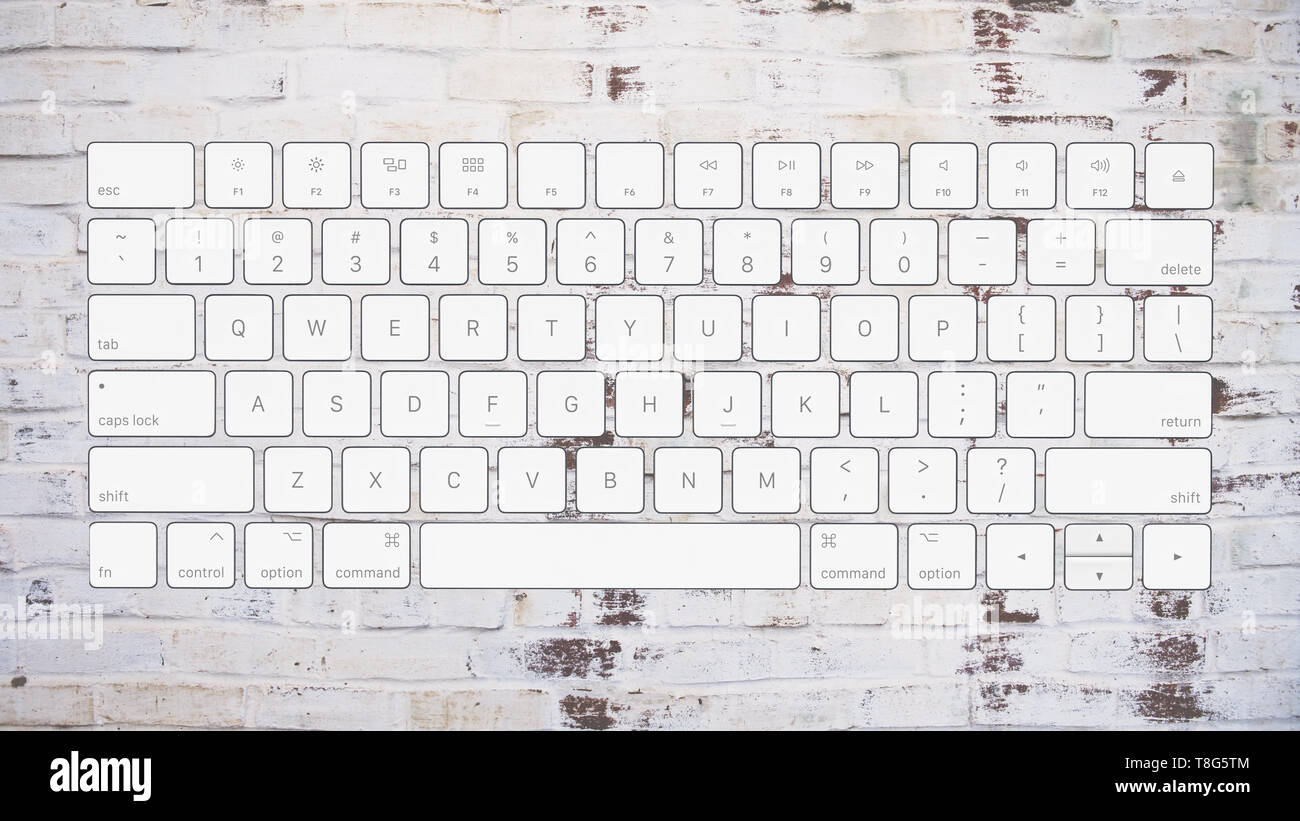 The English (US) keyboard is pictured in front of a nice brick ...