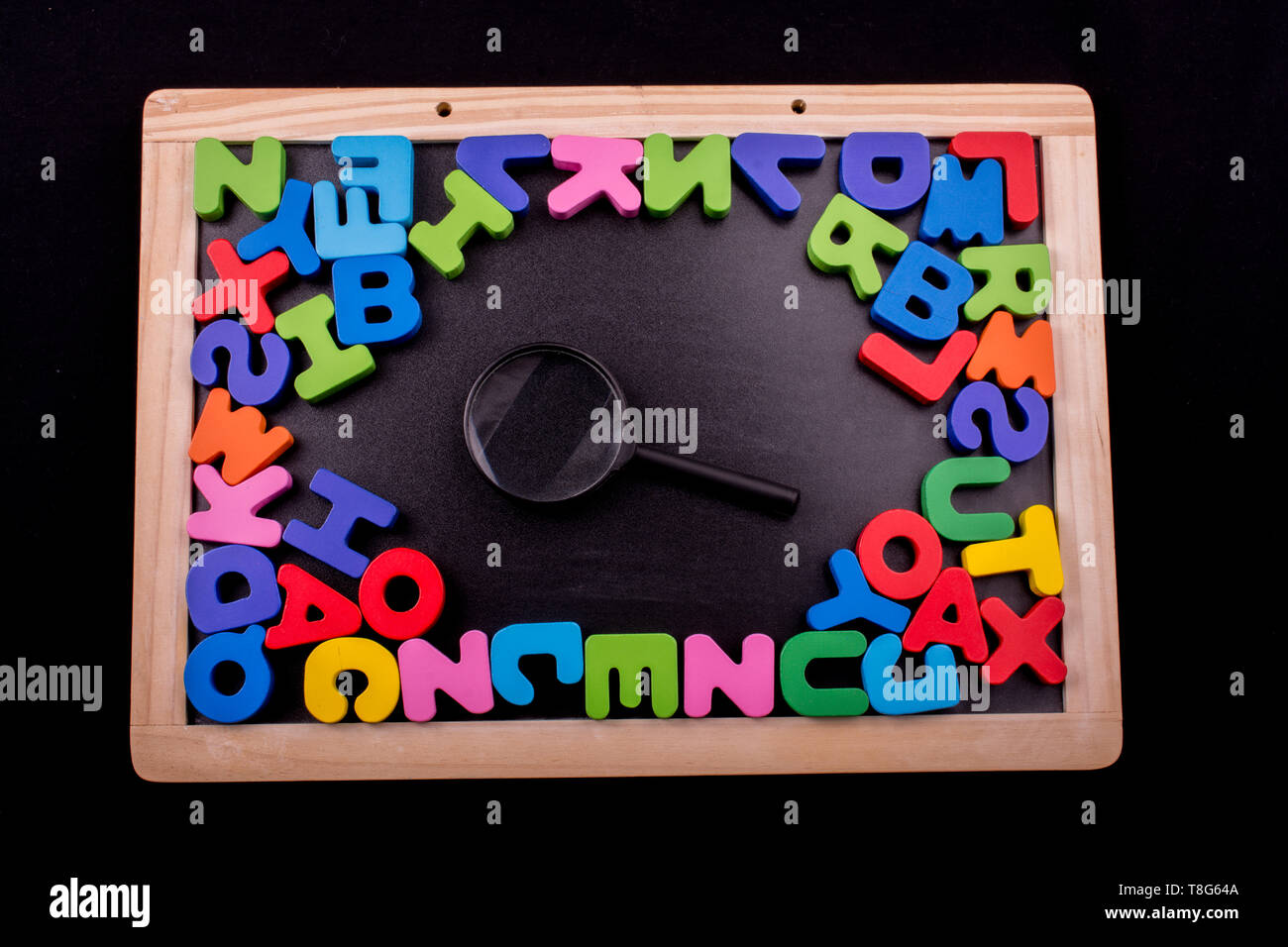 Magnifying glass and Colorful Letters of Alphabet Stock Photo - Alamy