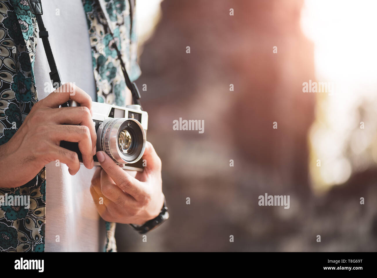 Young Man Photographer Traveler with backpack taking photo with his ...