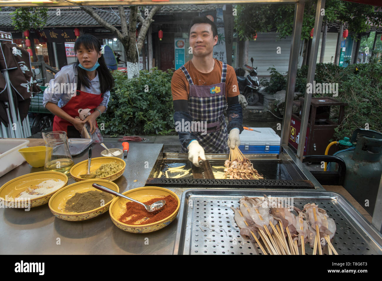 Chinese Street food. Food vendor sells food at a stall in Sichuan ...