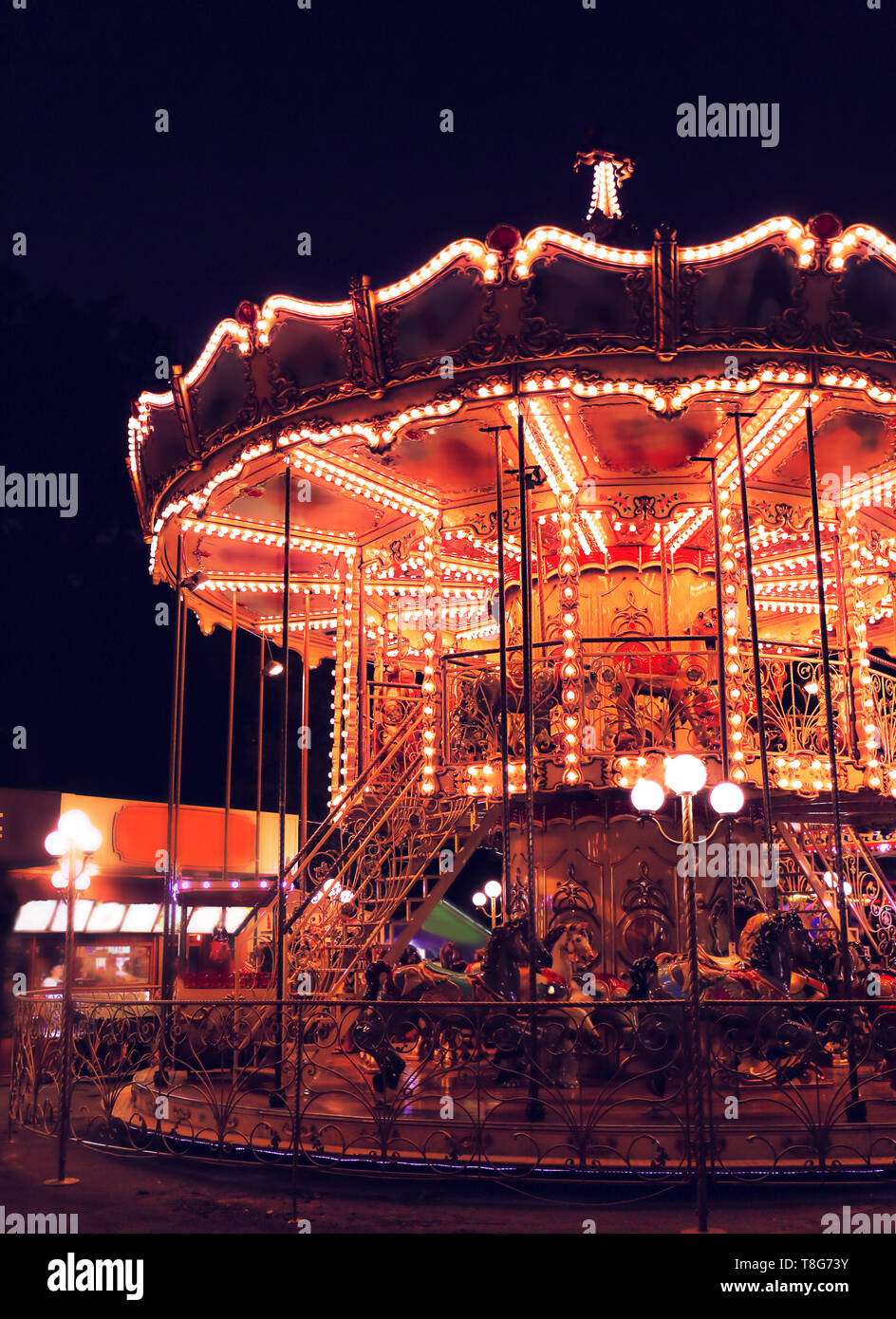 Beautiful carousel in city at night Stock Photo - Alamy