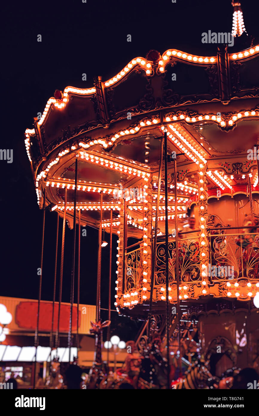 Beautiful carousel in city at night Stock Photo - Alamy
