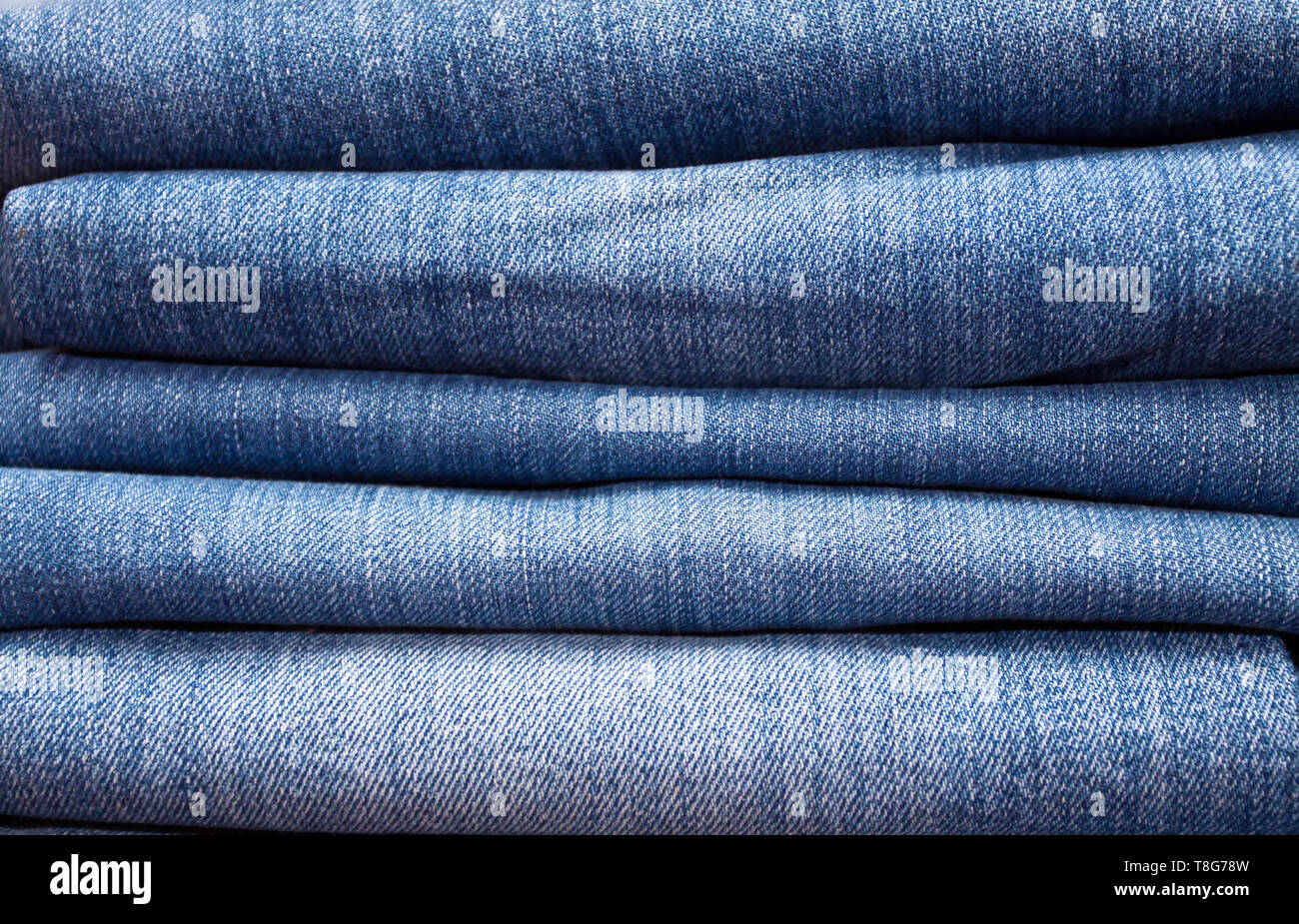 stack of various shades of jeans as background Stock Photo - Alamy