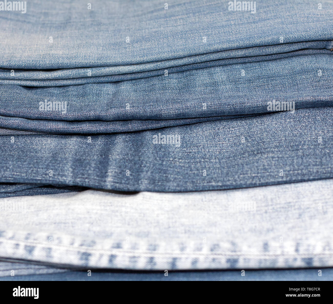stack of various shades of jeans as background Stock Photo - Alamy