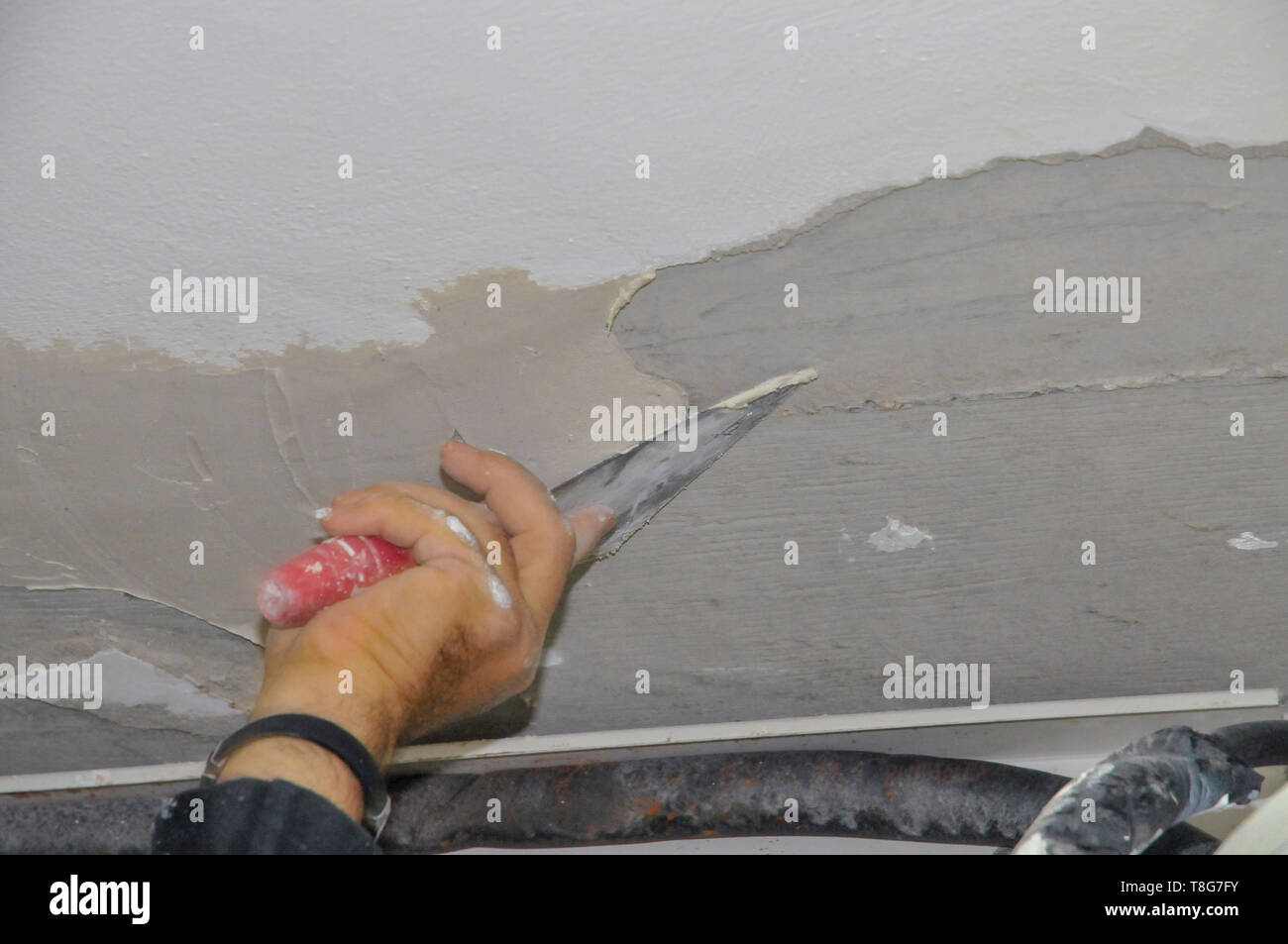 Home care. a room is being re plastered using a Putty knife. The ...