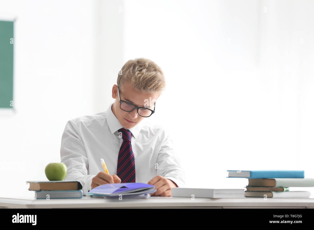 Teenage boy at lesson in classroom Stock Photo - Alamy