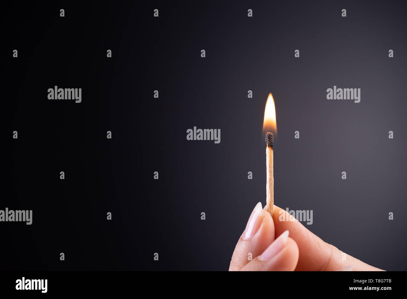 Close up woman hand holding a burning match Stock Photo - Alamy