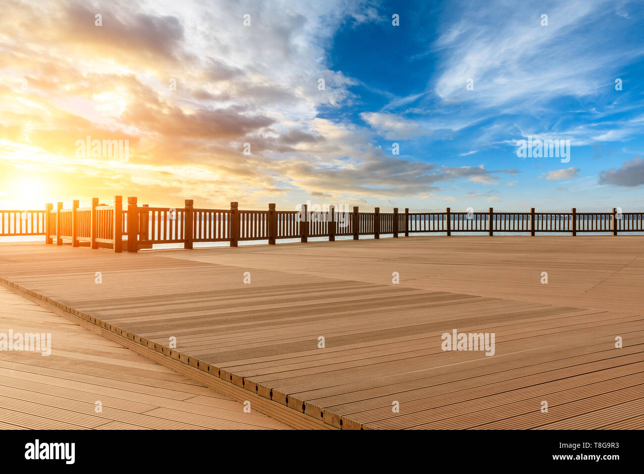 Lakeside wood floor platform and sky clouds at sunset Stock Photo - Alamy