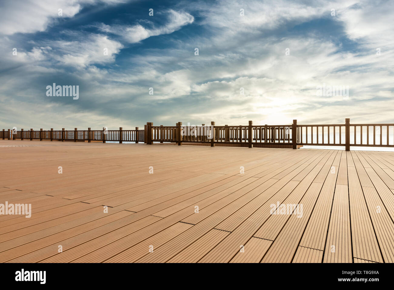 Lakeside wood floor platform and sky clouds at sunset Stock Photo - Alamy