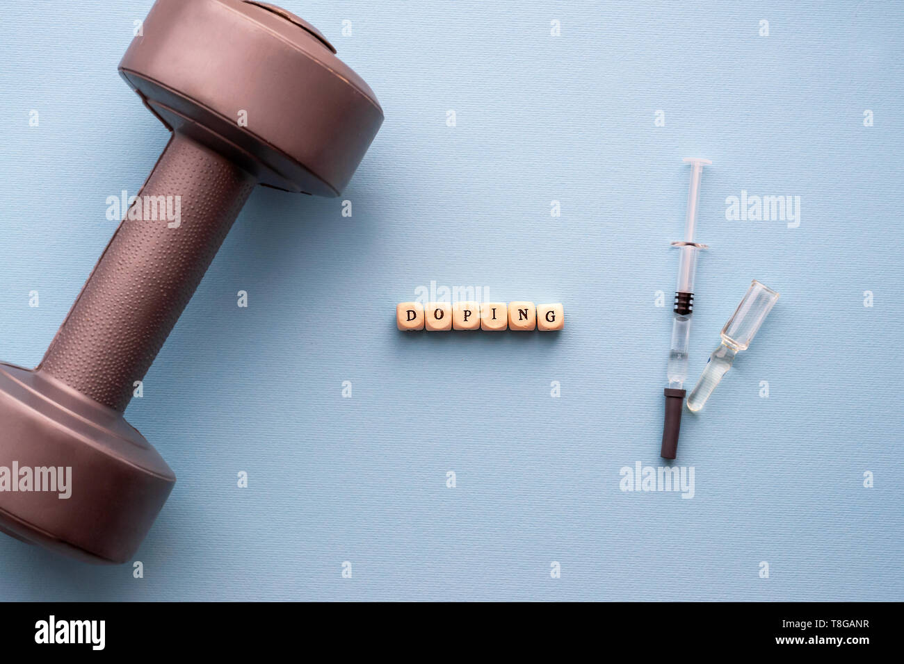 The concept of doping in sport. Inscription Doping on a blue background ...