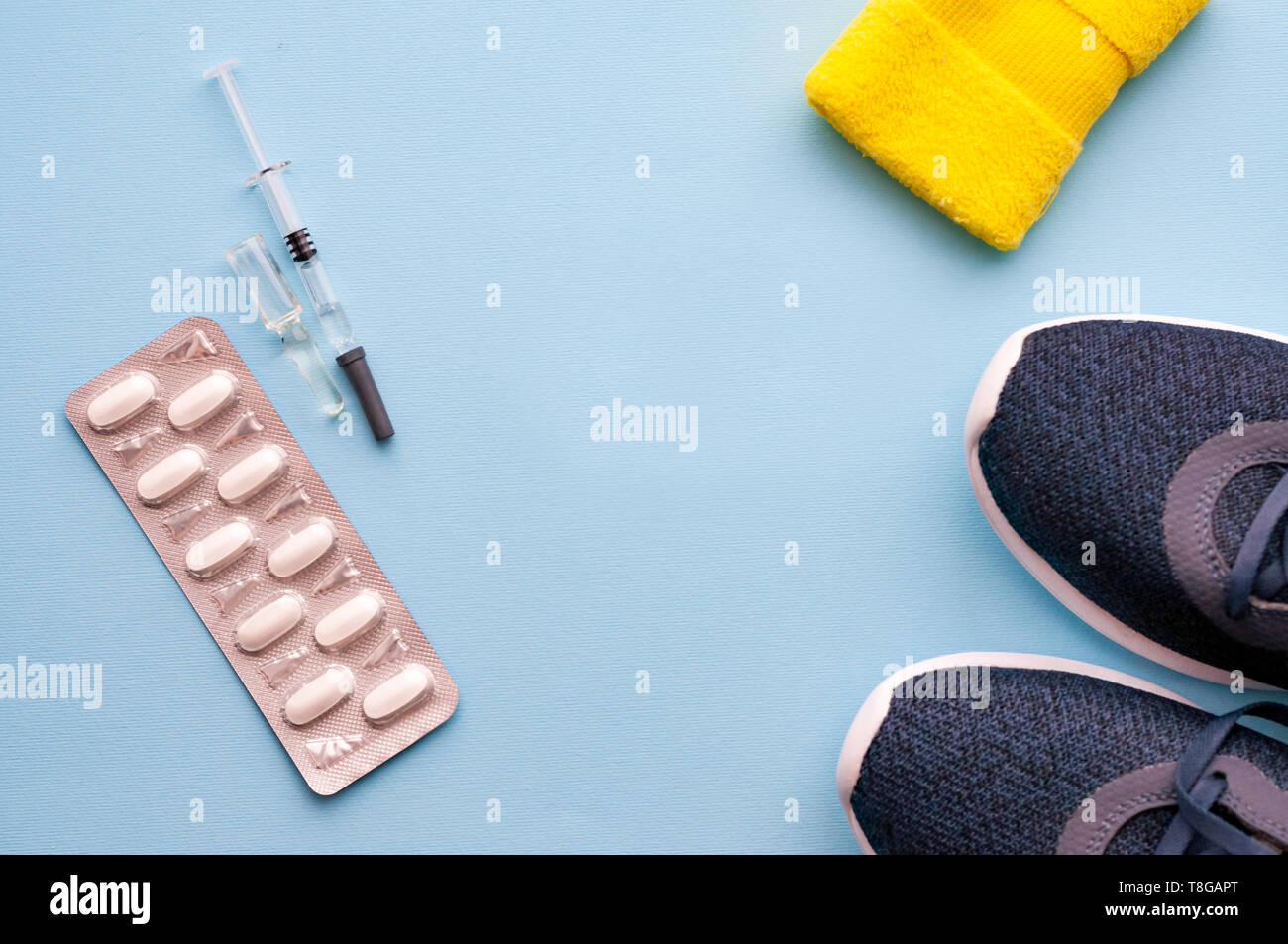 The concept of doping in sport. Sports shoes, pills, syringe with ...