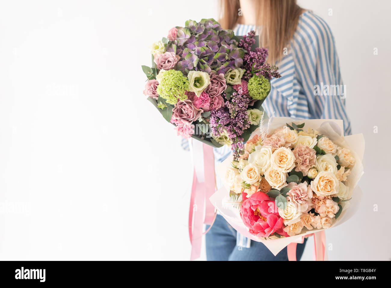 Two Beautiful bouquets of mixed flowers in womans hands. the work of ...