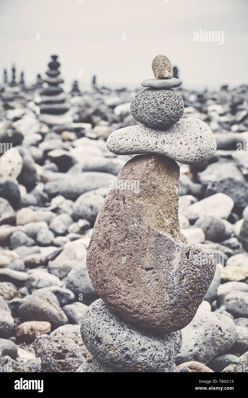 Color toned picture of a volcanic stones stack on a beach, selective ...