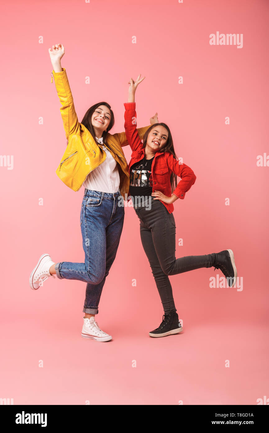 Full length photo of laughing girls in casual standing together ...