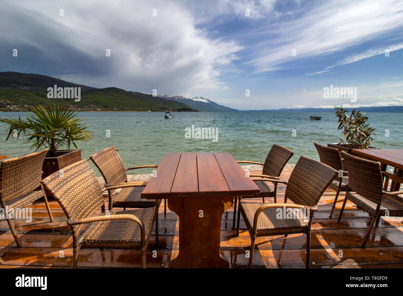 A look through the wet tables and chairs. The stunning sky above Ohrid ...