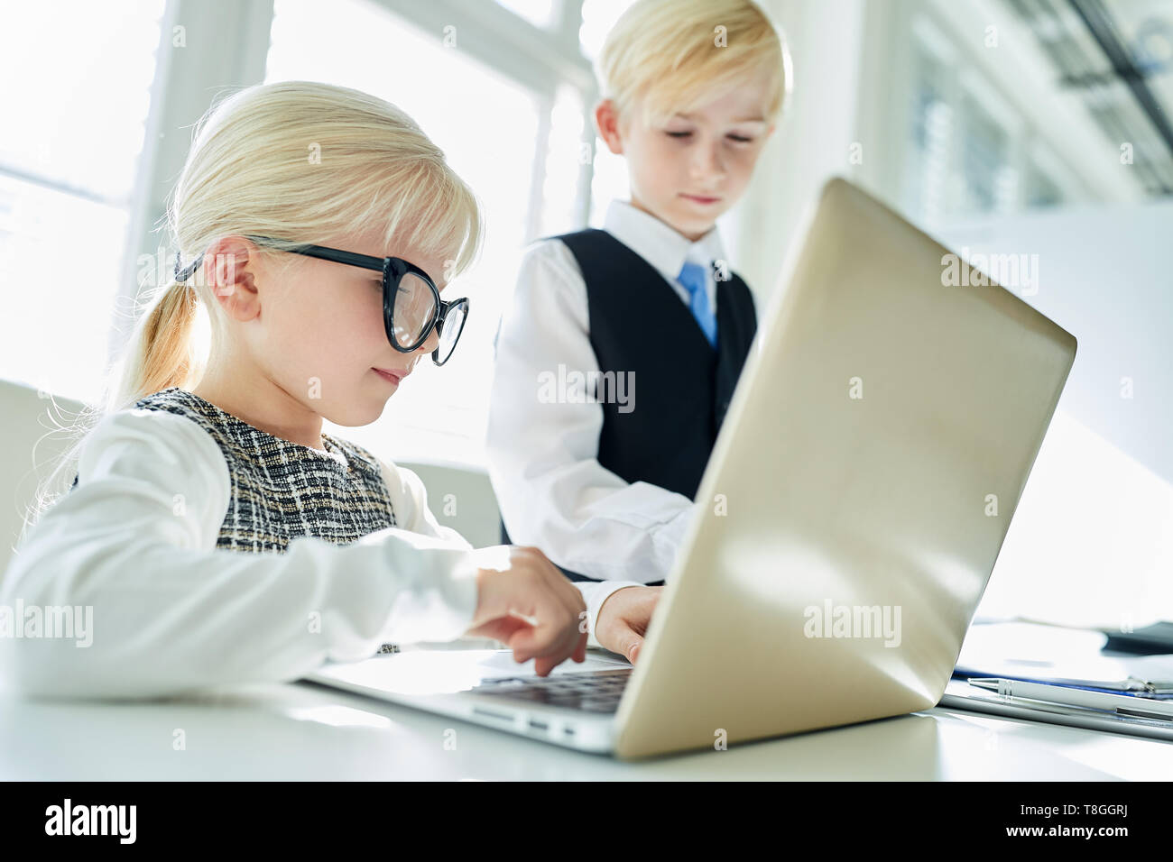 Boy and girl as business team work together on laptop computer Stock ...