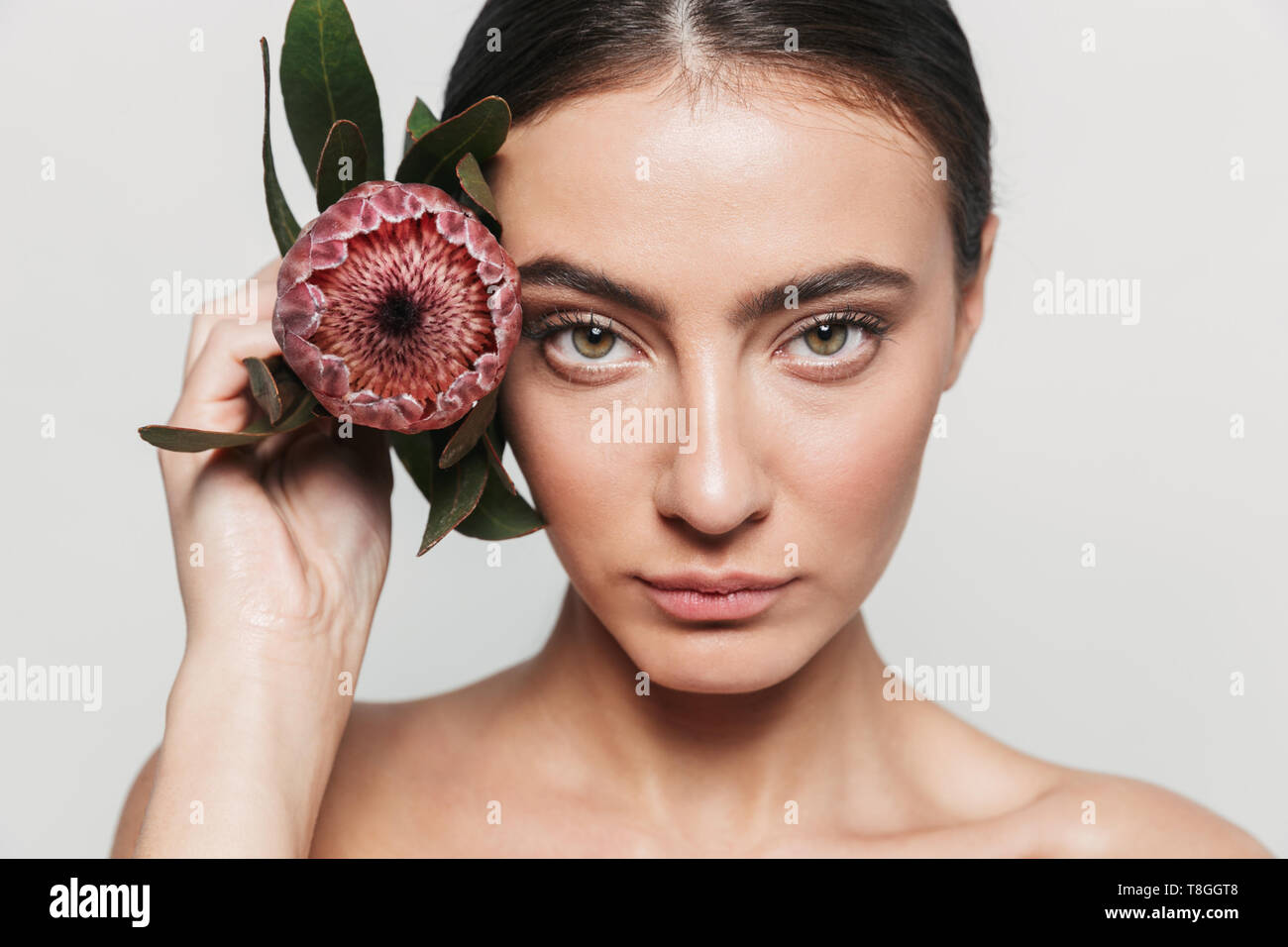 Woman and flower over eye beauty hi-res stock photography and images ...