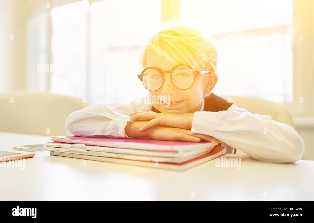Smart kid with glasses as a student in the classroom at the desk Stock ...