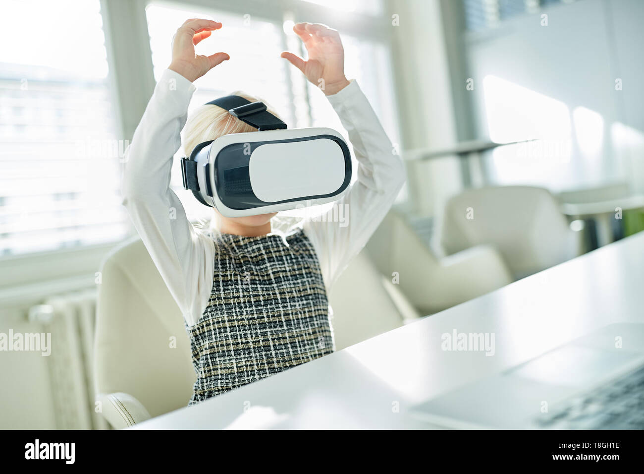 Child with VR glasses explores the virtual reality with touch and feel ...